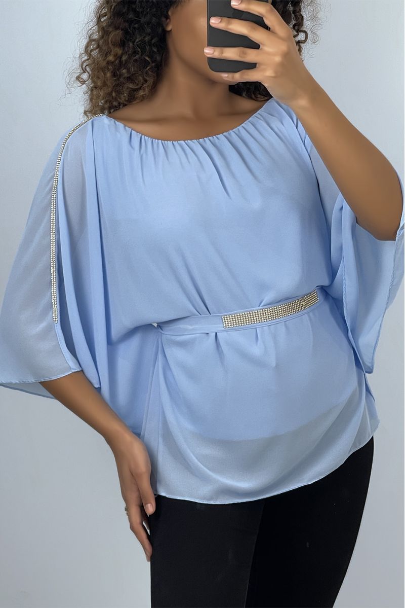 Turquoise top with batwing sleeves, belted at the waist